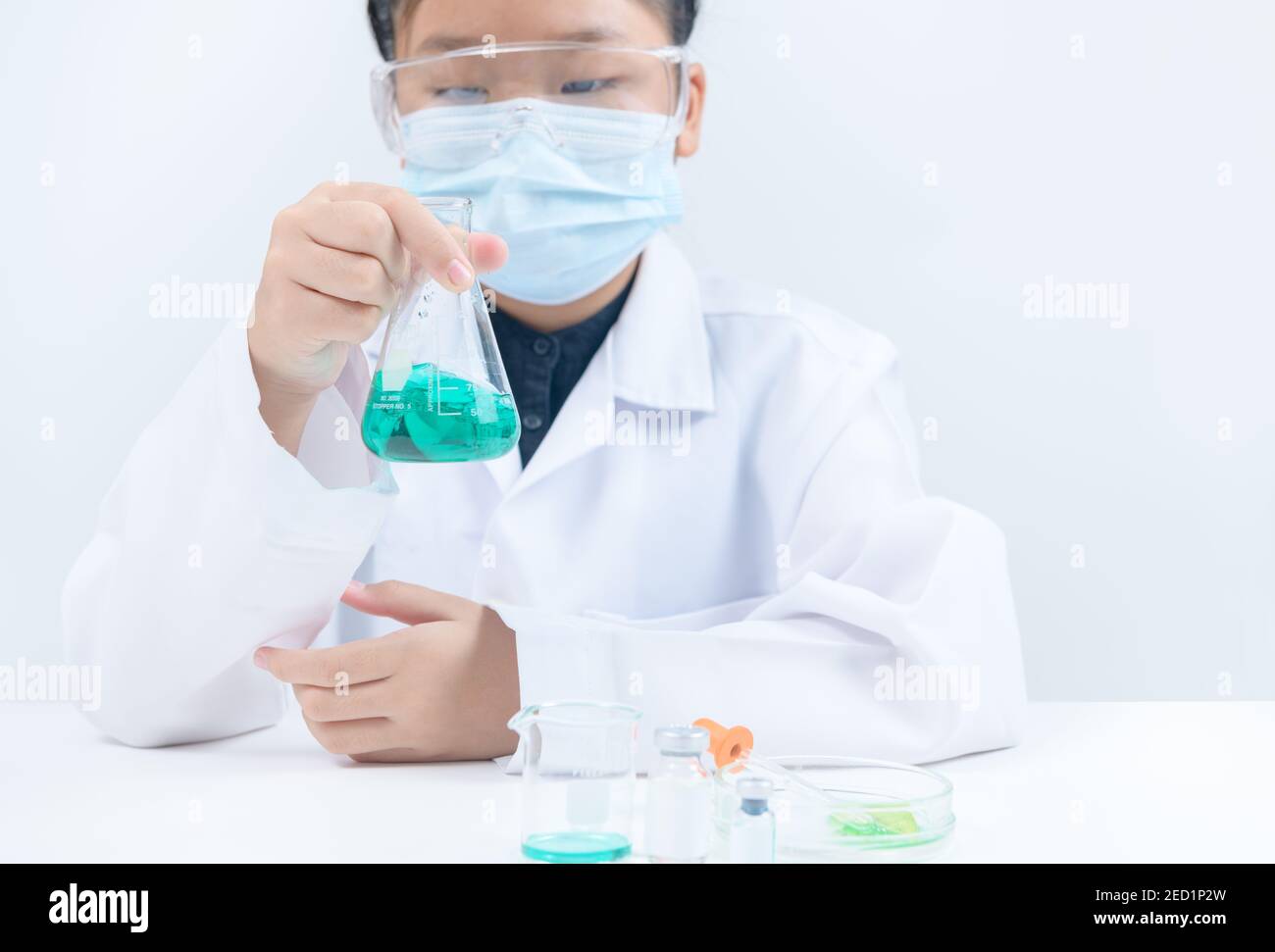 Young Scientists shaking blue liquid chemical in Erlenmeyer flask ...