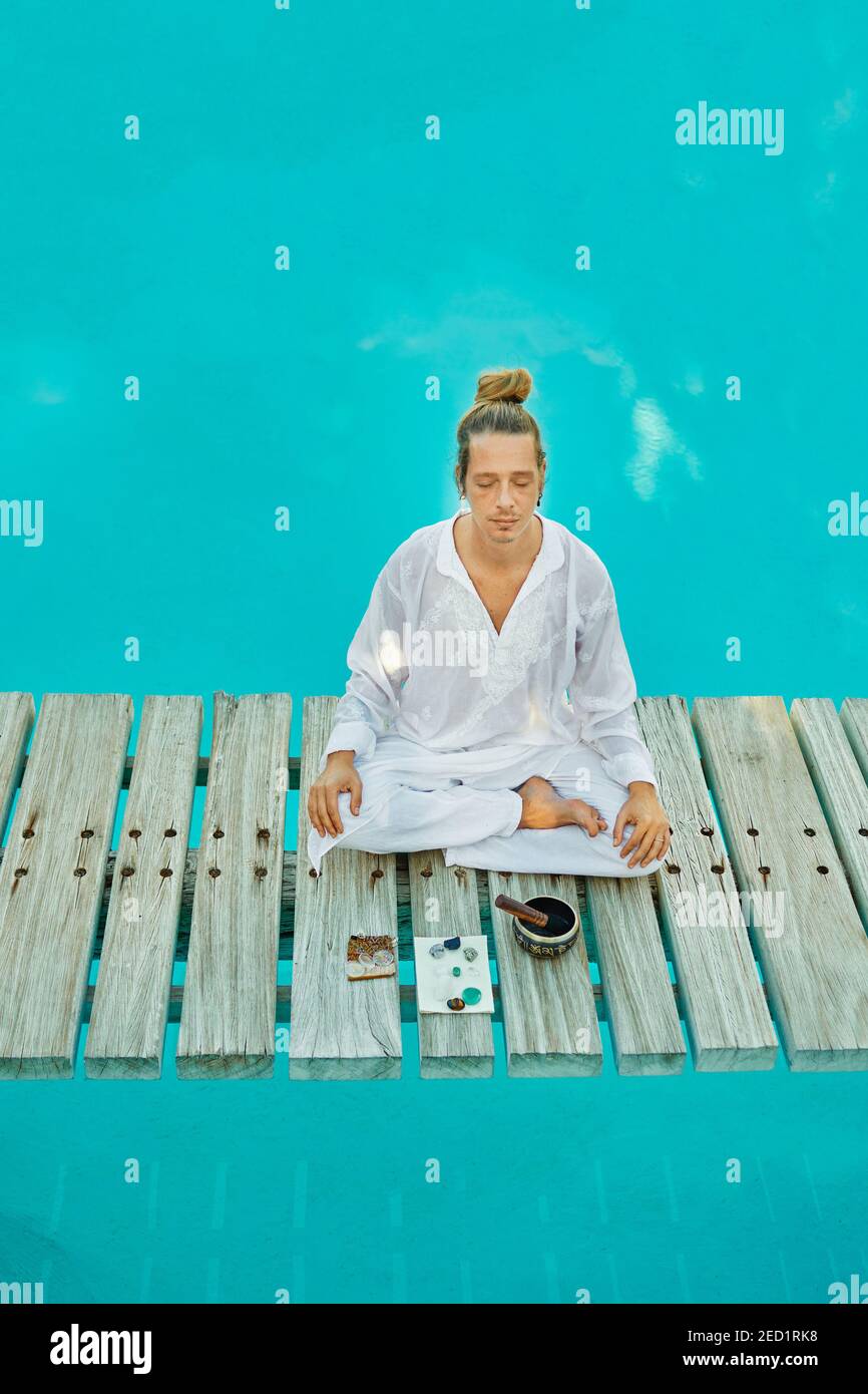 Cheerful female influencer waving hand while recording vlog on mobile ...