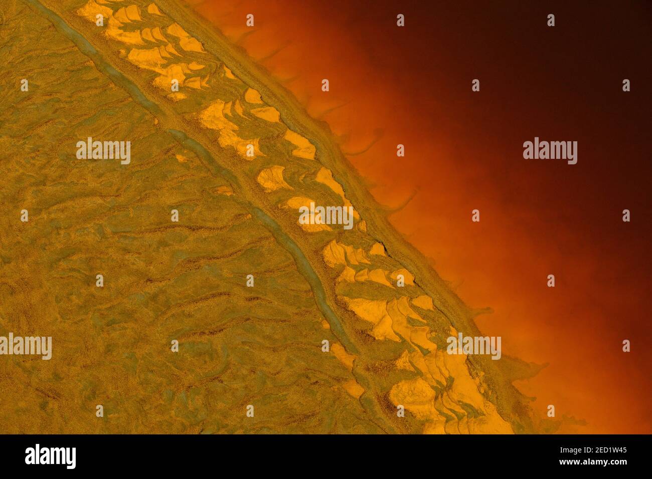 Majestic view of orange rock in river with fast flow in long exposure ...