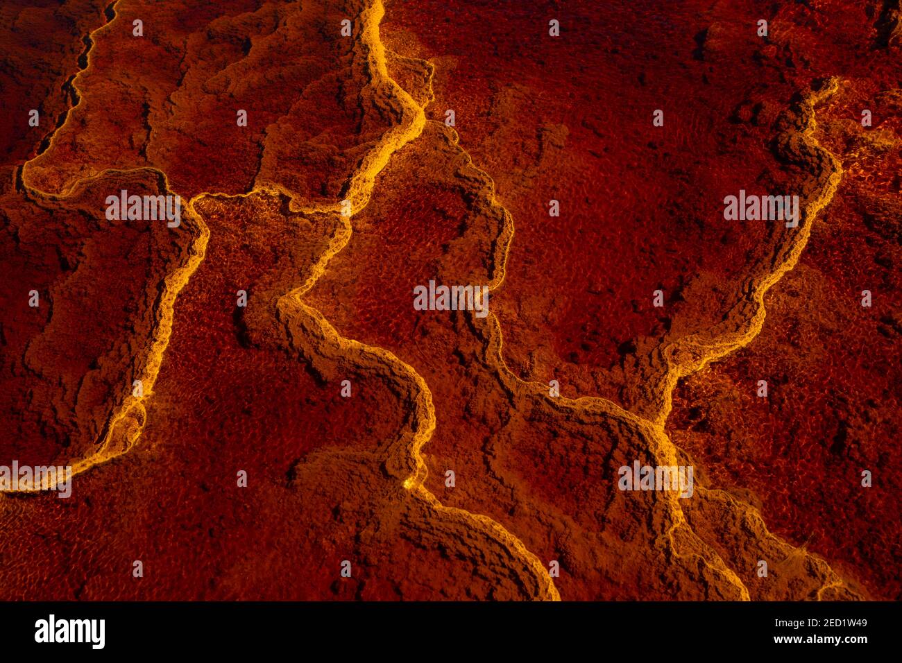 Majestic view of orange rock in river with fast flow in long exposure ...