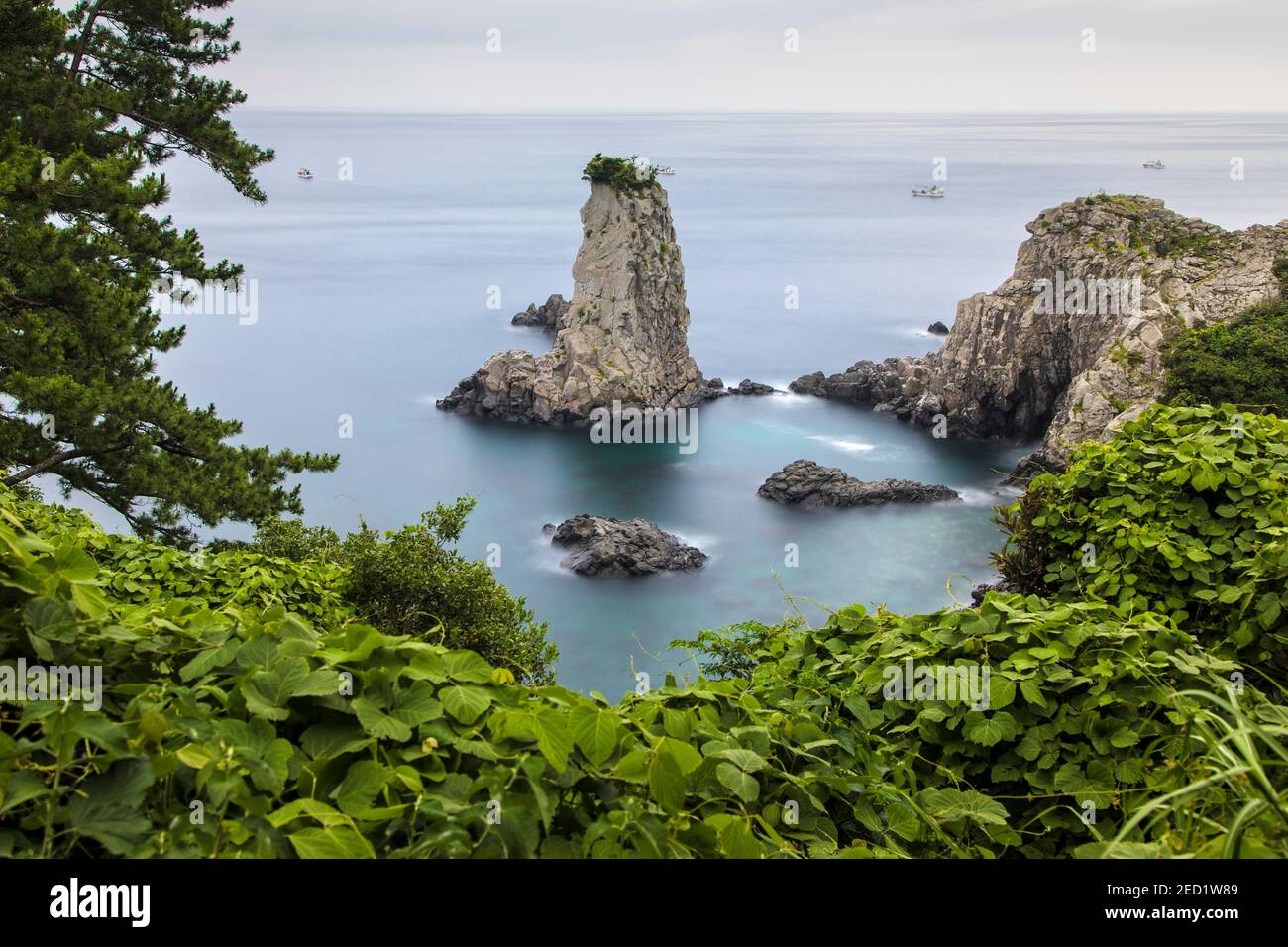 Breathtaking scenery of Oedolgae rock in sea water located on tropical ...