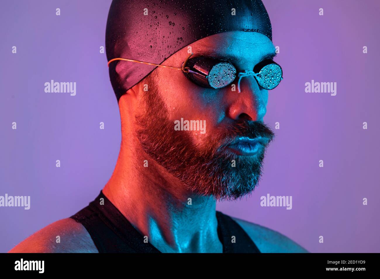 Side view studio portrait of a swimmer with cap and goggles Stock Photo ...
