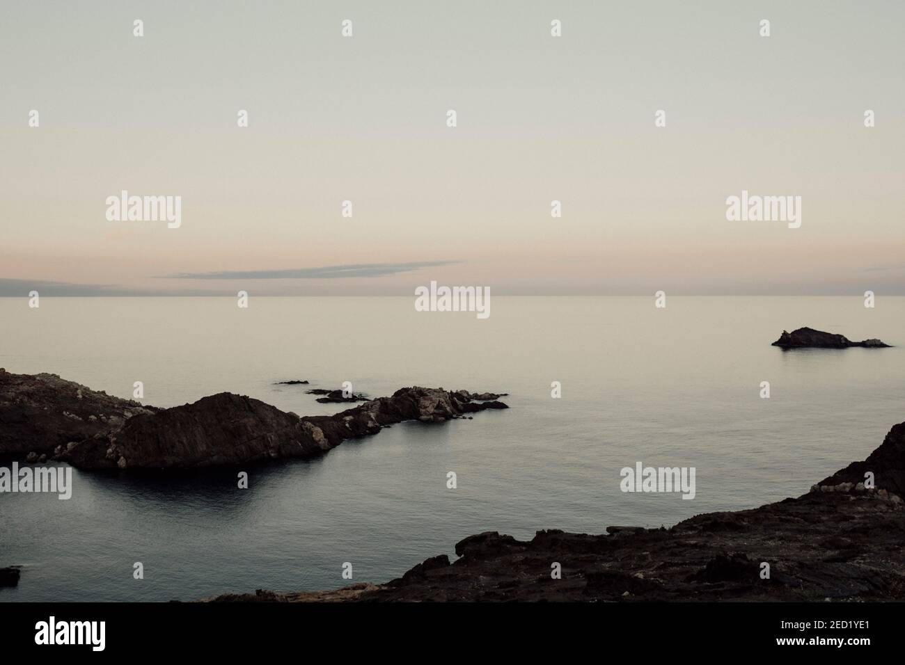 From above breathtaking landscape of mountain cliffs in waving sea with ...