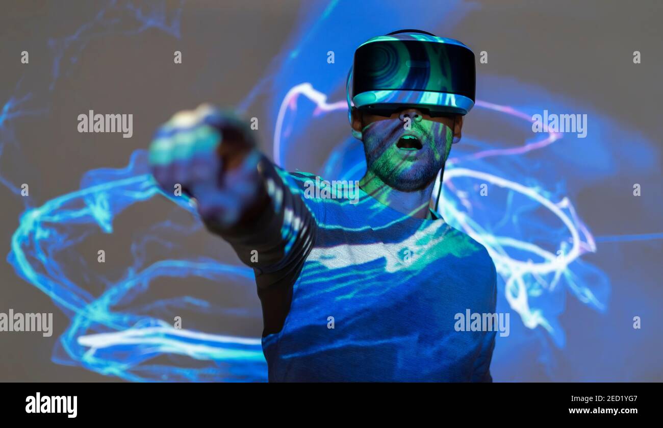 Unrecognizable young male in casual wear and VR headset getting new ...