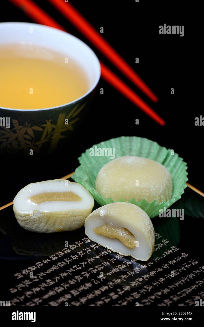 Mochis with tea and chopsticks, Japanese sticky rice cake with green ...