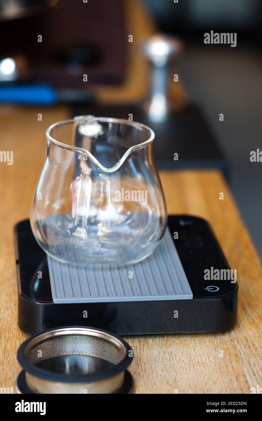 empty glass teapot server on digital scales closeup on table in coffee ...