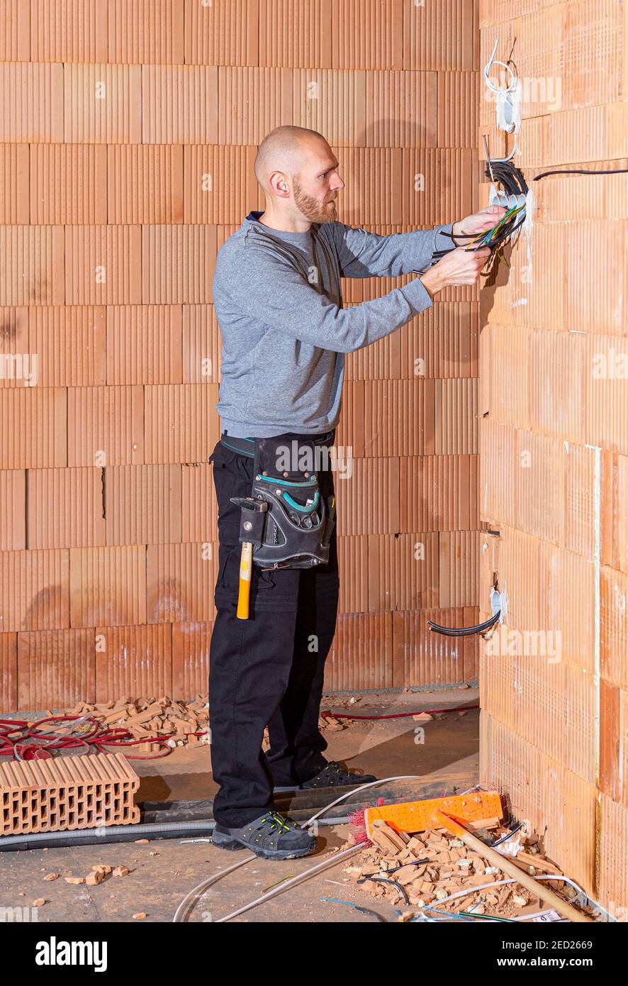Male builder wiring inside hi-res stock photography and images - Alamy