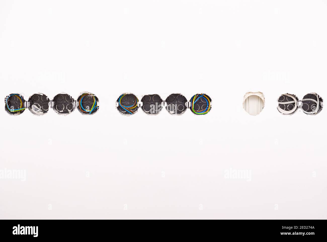 Socket back boxes with wires in a wall. Cabling background. Colorful ...