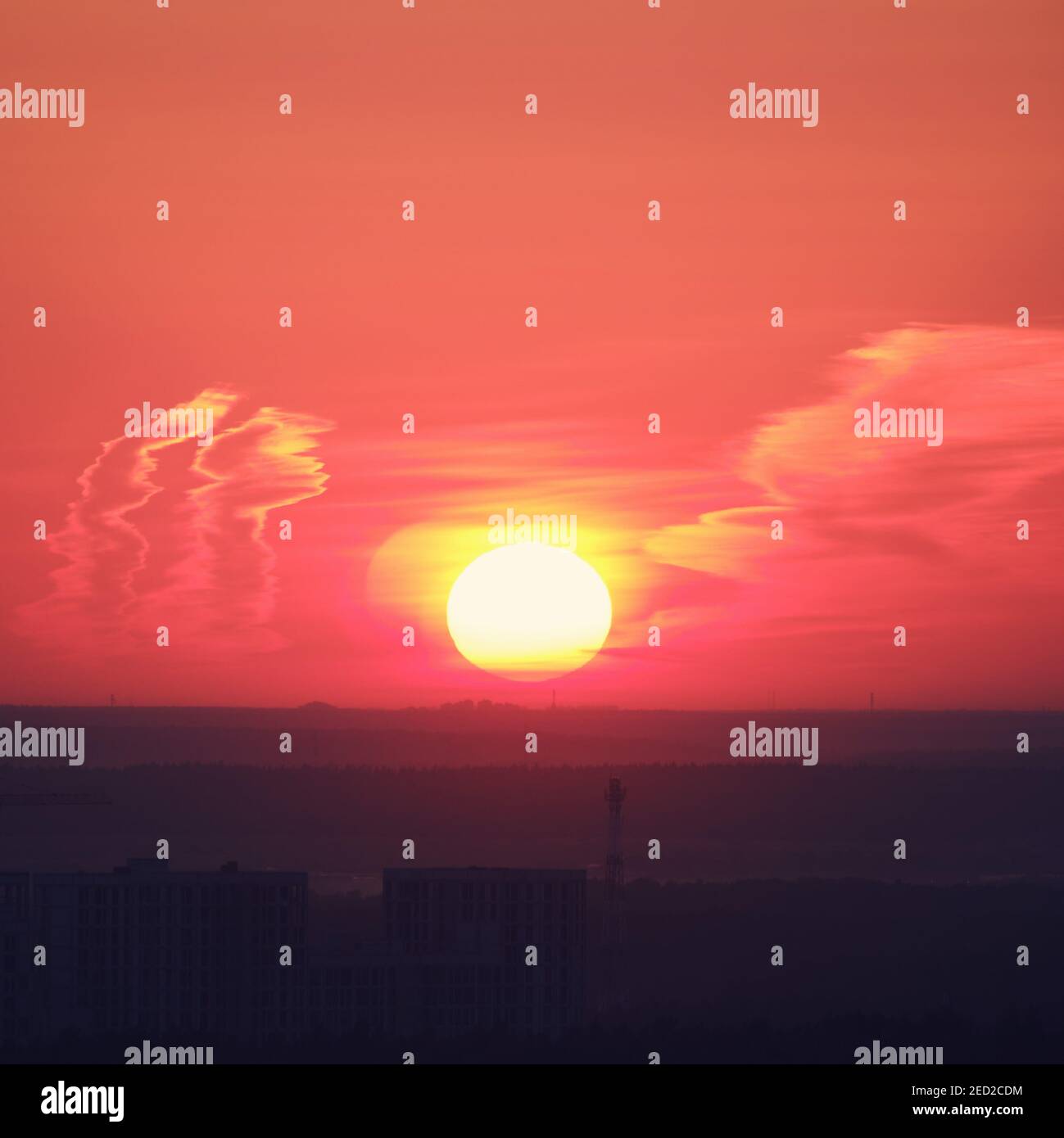 Big red sun over city houses at sunset, top view Stock Photo - Alamy