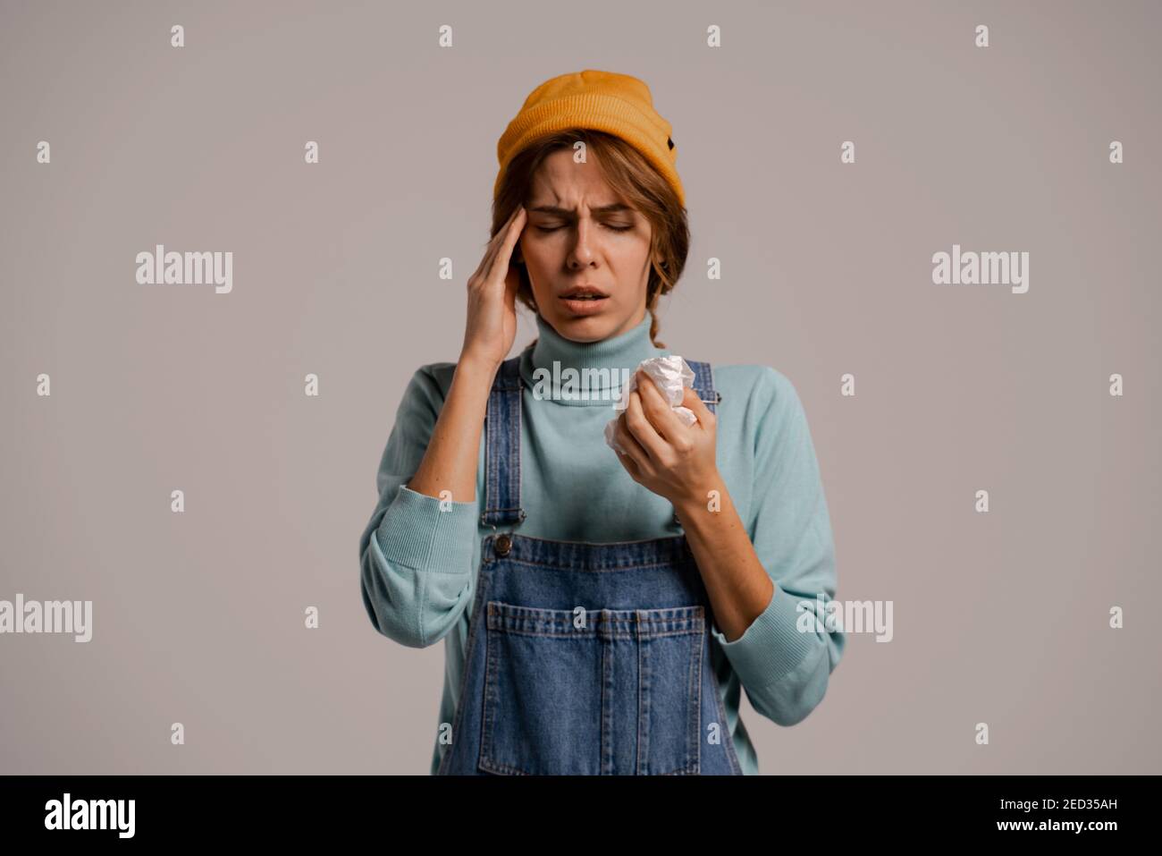 Photo of cute female hipster has headache with running nose and looks ...