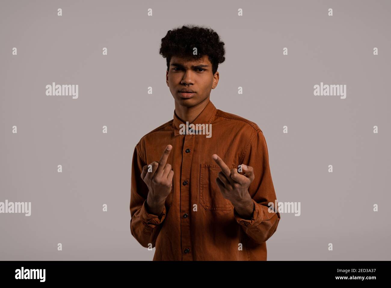 Photo of black man shows middle fingers in camera and looks rude. Male ...