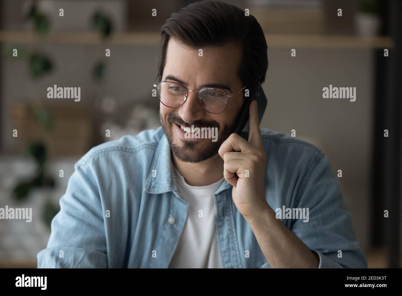 Happy handsome young guy enjoy phone conversation with pleasant person ...