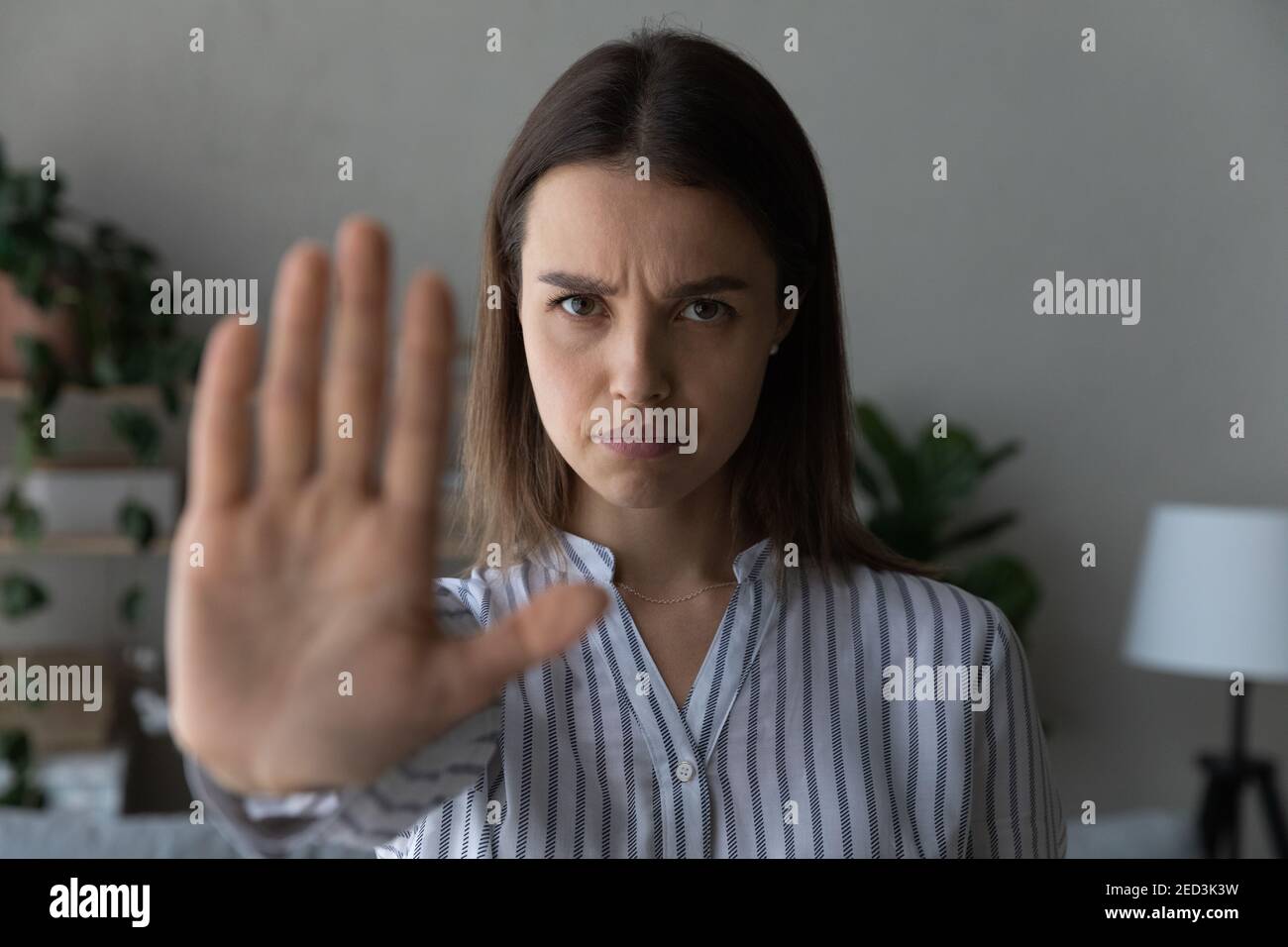 Millennial female look at camera raise palm in prohibition gesture ...