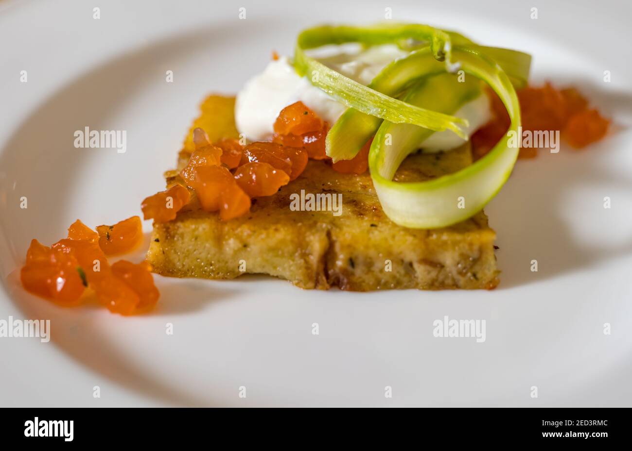 Fine dining plate of food of cured sea trout tartare cubes, shaved ...