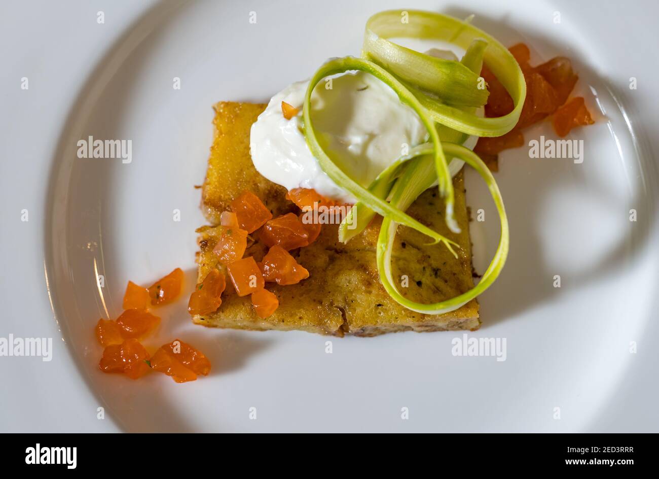 Fine dining plate of food of cured sea trout tartare cubes, shaved ...