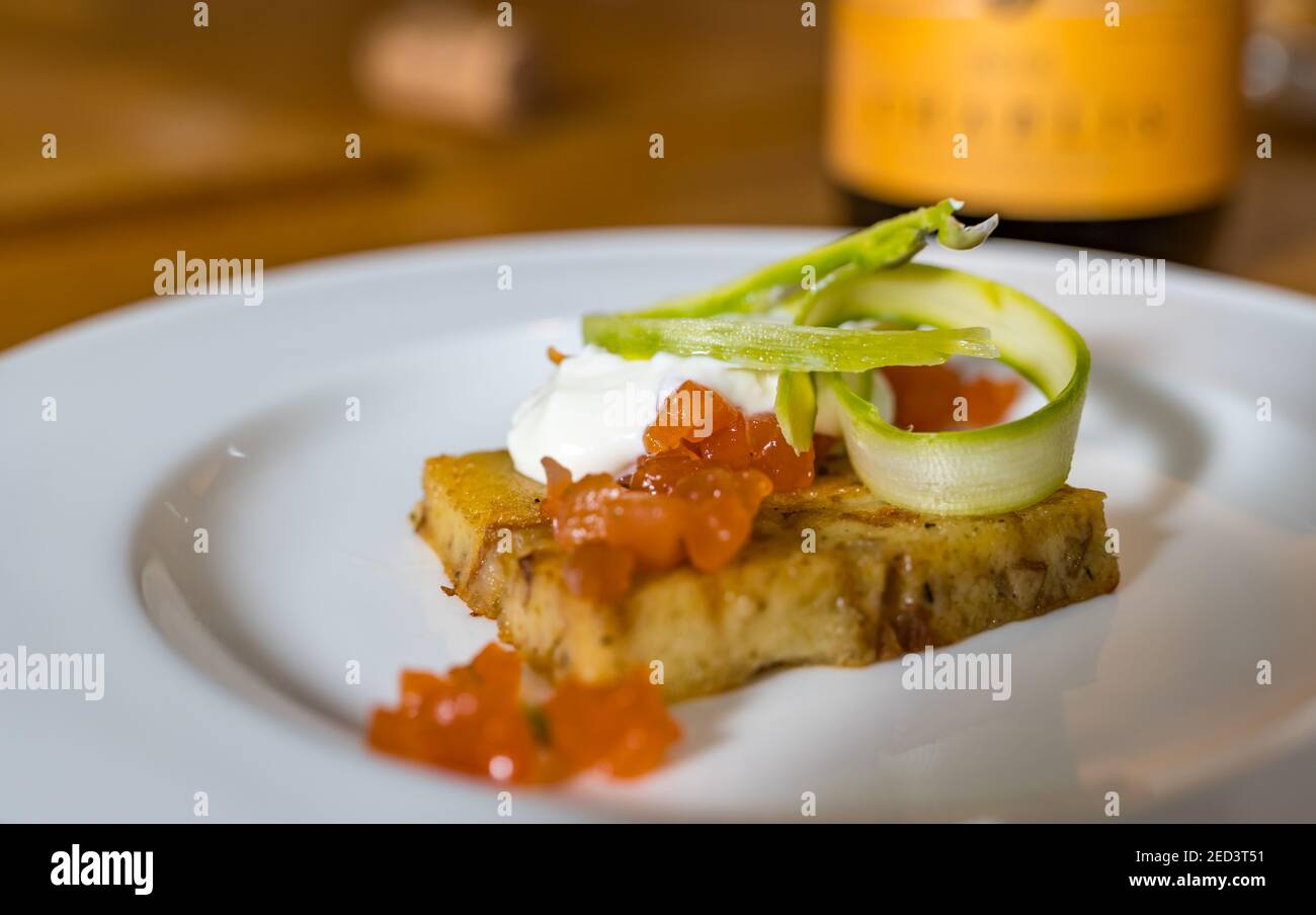 Fine dining plate of food of cured sea trout tartare cubes, shaved ...