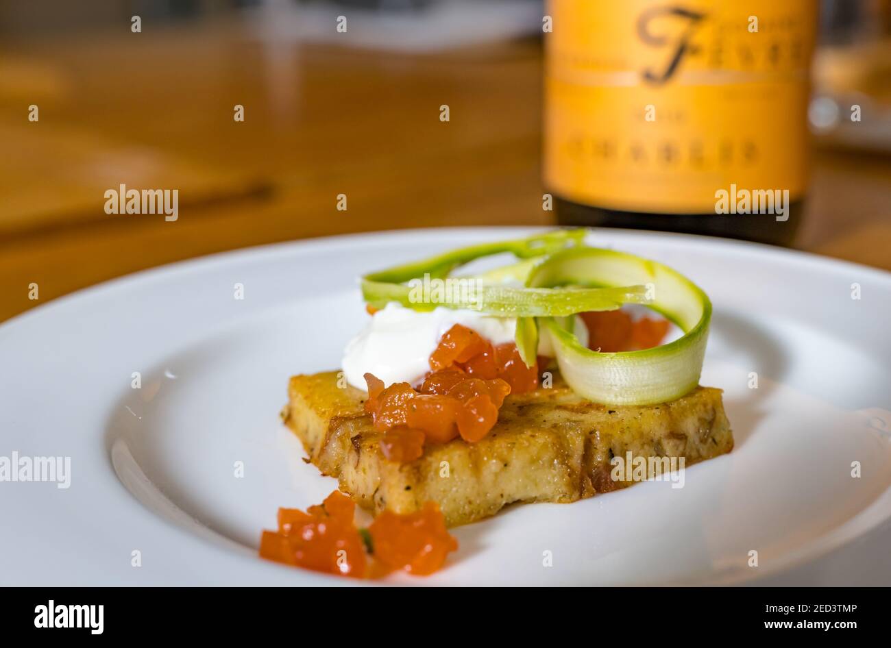 Fine dining plate of food of cured sea trout tartare cubes, shaved ...