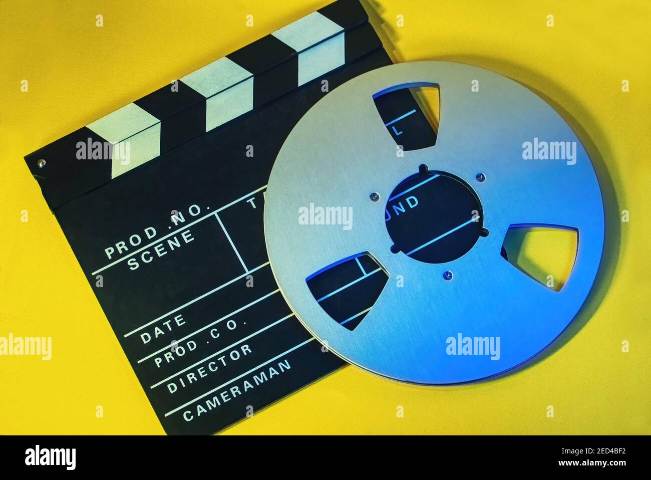 full frame photo of a film board and a tape spool in a yellow ...