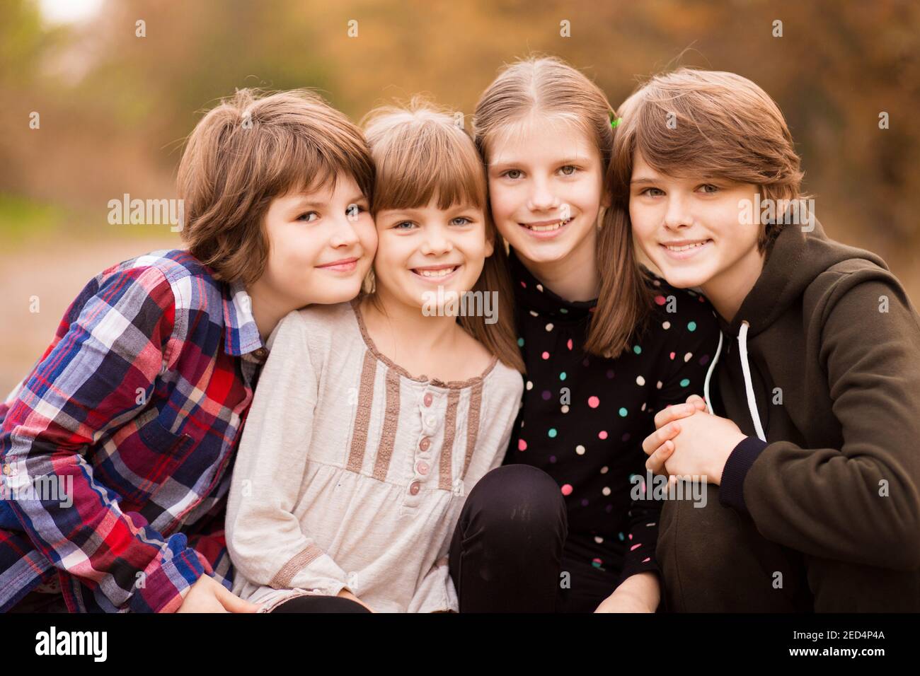Young four beautiful sisters hugging each other, strong friendship ...