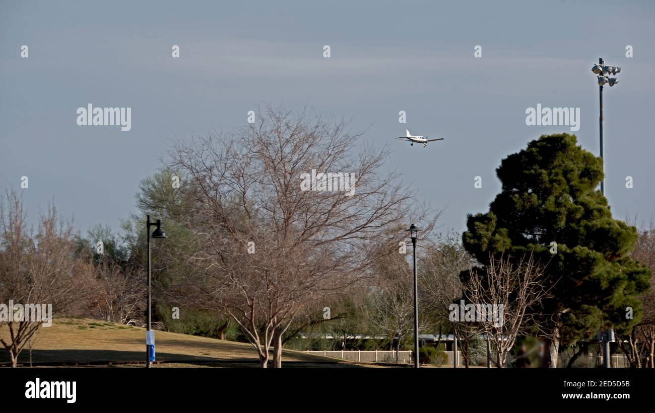 A small aircraft flying very low over a lake and nice landscape Stock ...