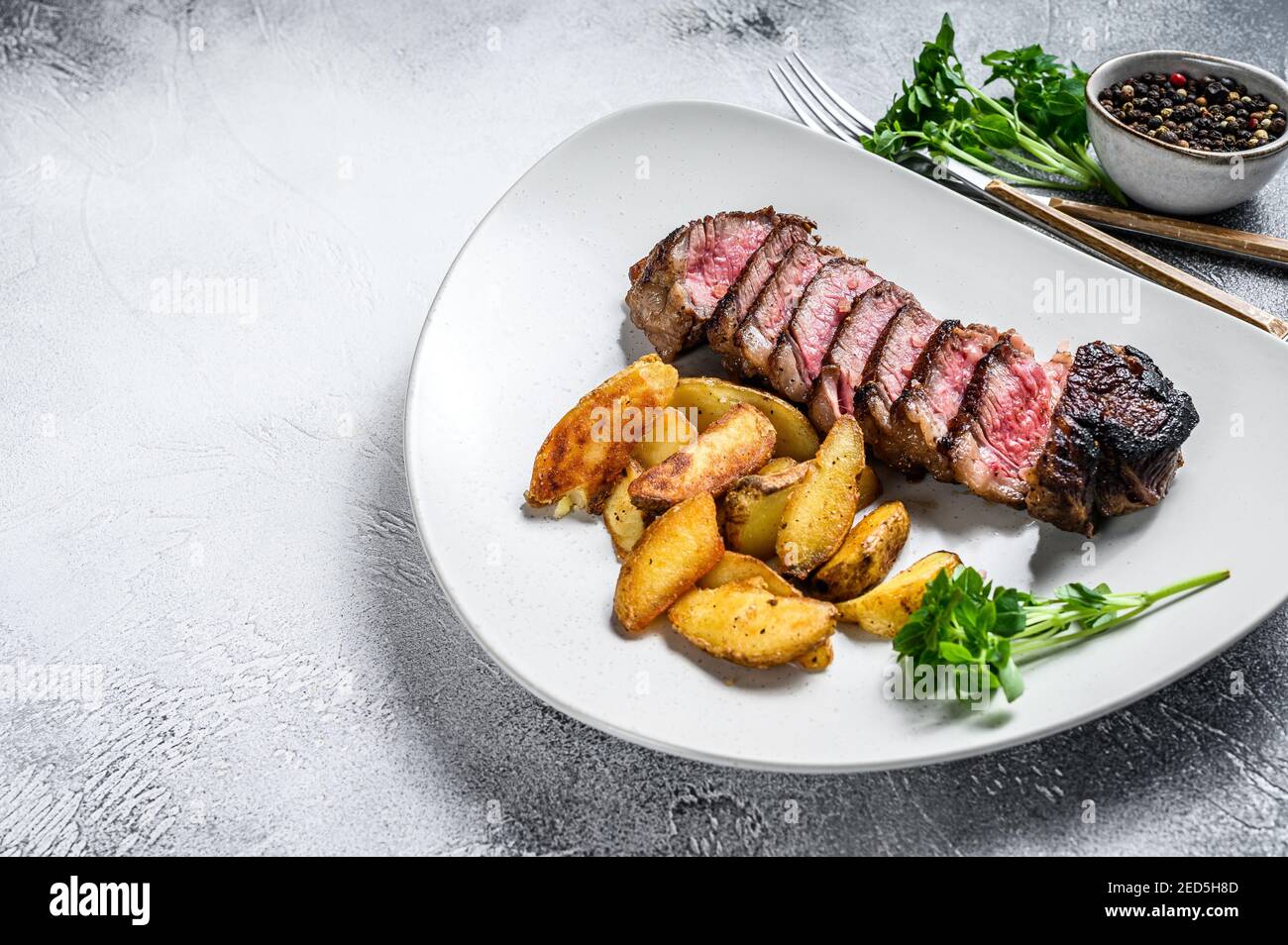 Sliced Grilled rump Beef steak with potato. White background. Top view ...