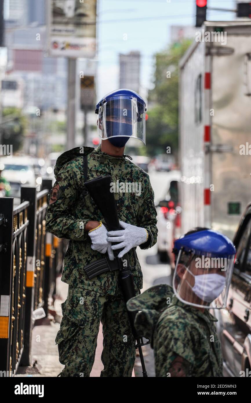 Policemen wearing protective face shields and masks stop and inspect ...