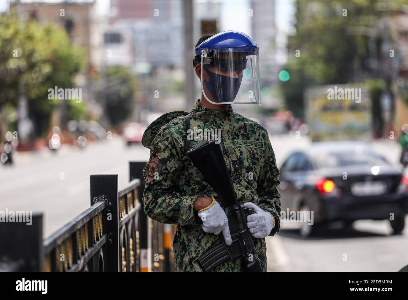 Policemen wearing protective face shields and masks stop and inspect ...