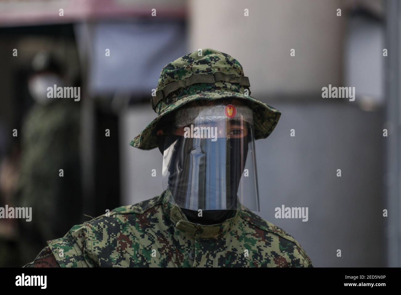 Policemen wearing protective face shields and masks stop and inspect ...