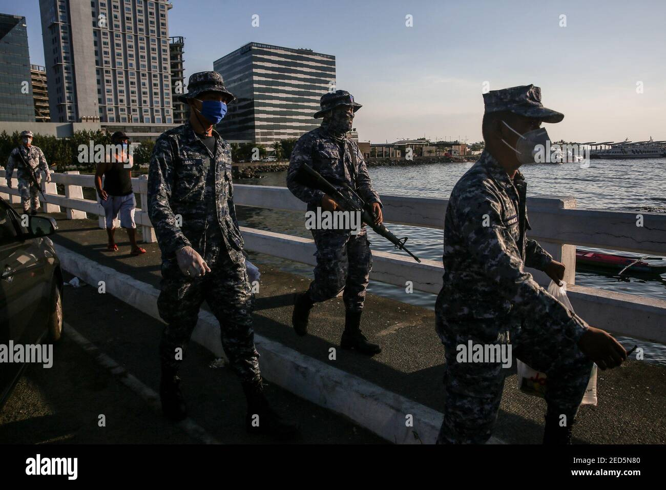 Members of the Philippine Coast Guard patrol the seaside near ...