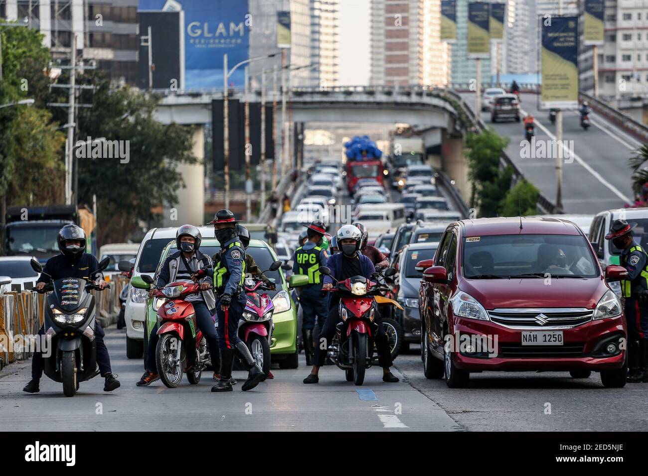 Policemen stop and inspect motorists along a highway during the COVID ...