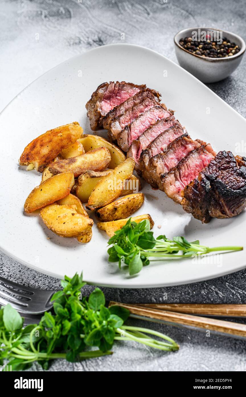 Sliced Grilled rump Beef steak with potato. White background. Top view ...