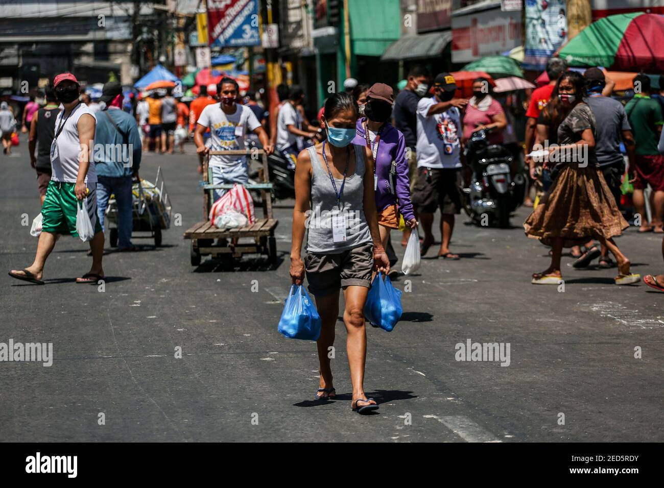 People wearing protective masks maintain social distancing near a ...