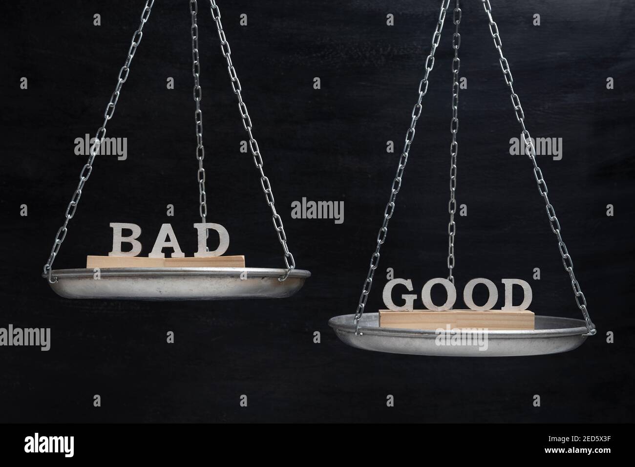 Words Bad and Good in balance. Scales on black background close up ...