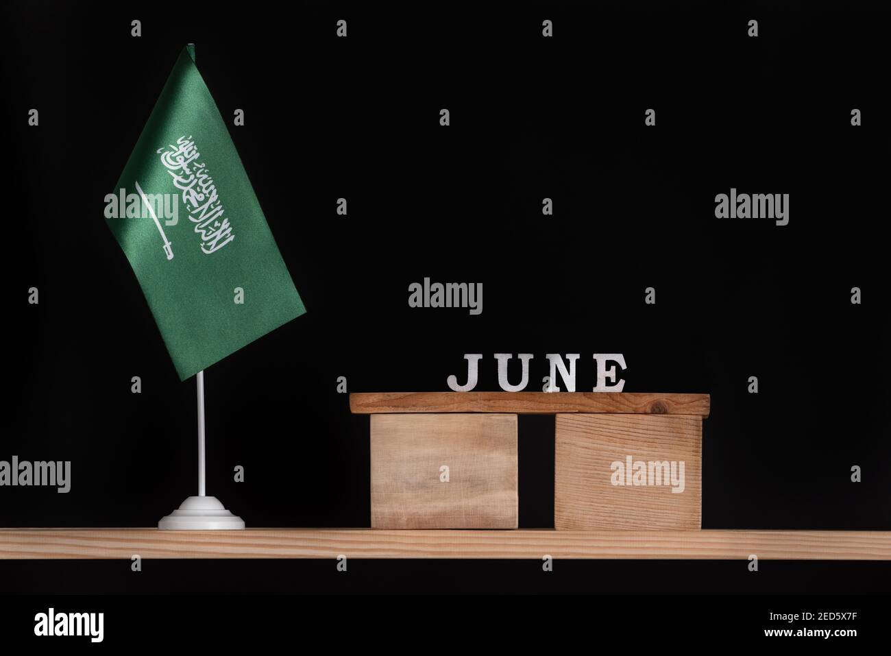Wooden calendar of June with Saudi Arabia flag on black background ...