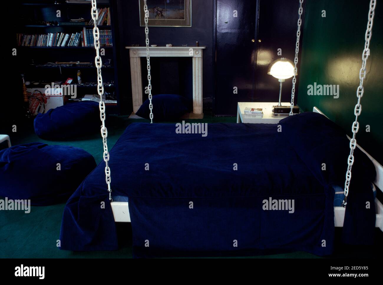 Blue decorated bedroom with bed suspended on chains from ceiling Stock ...