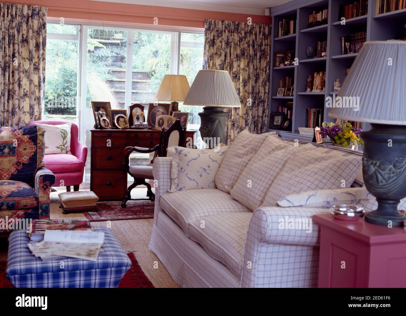 Blue checked ottoman stool and checked white sofa in country sitting ...