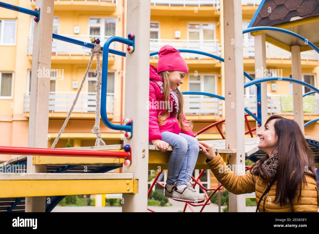 Mother with girl at playground. Woman holding she Stock Photo - Alamy