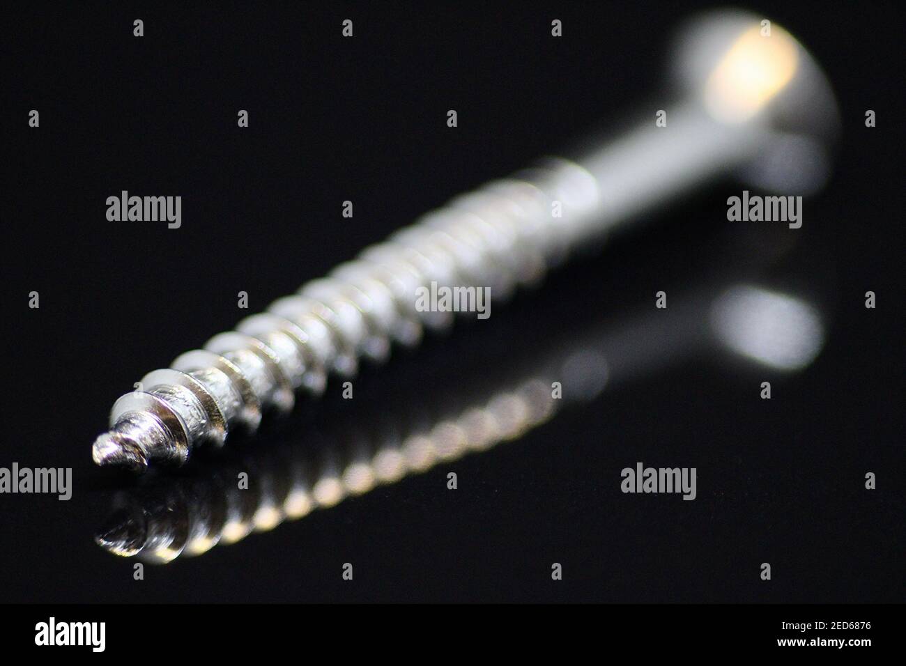 Macro Close up of a Steel Screw on Black Reflective Surface and ...