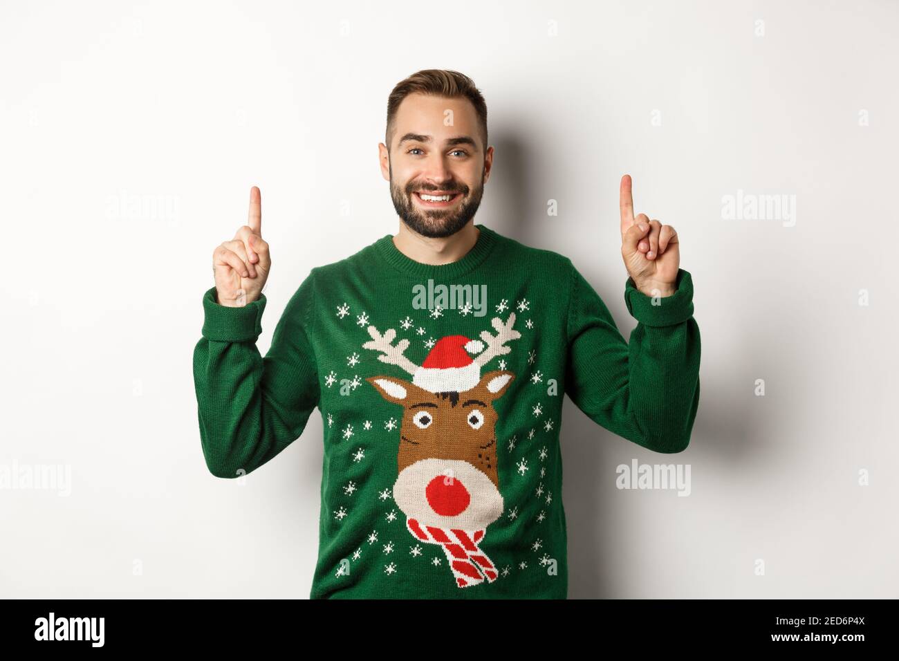 Winter holidays and christmas. Handsome bearded man in green sweater ...