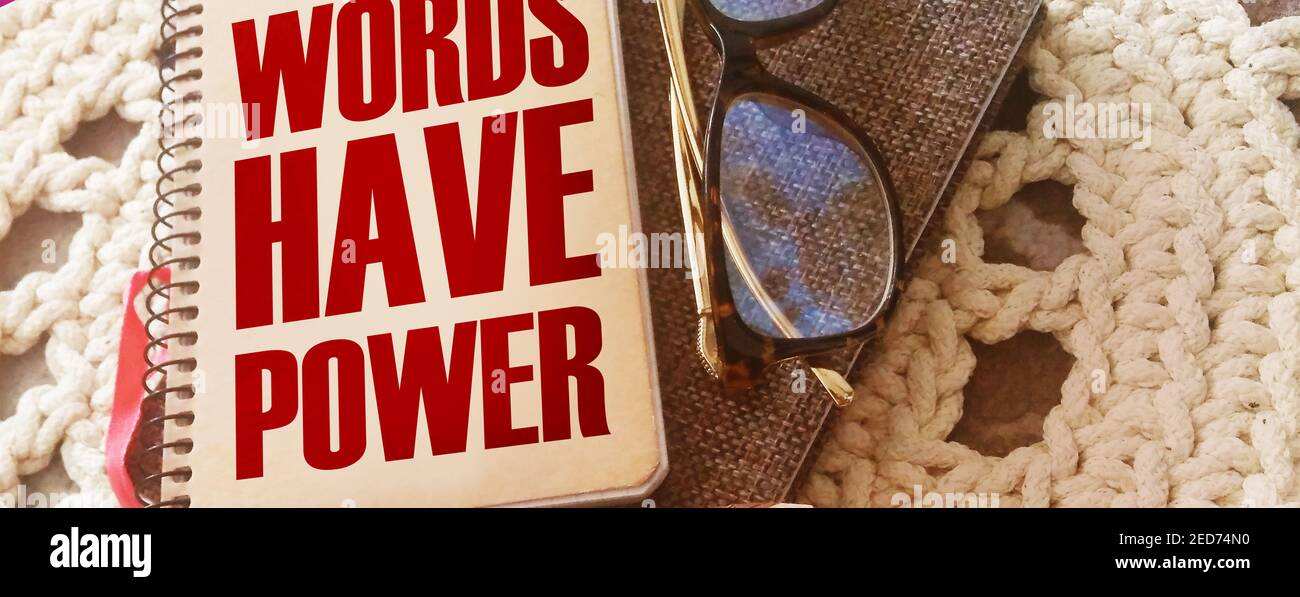 Words have power text on the cover of notebook, glasses and pen on ...