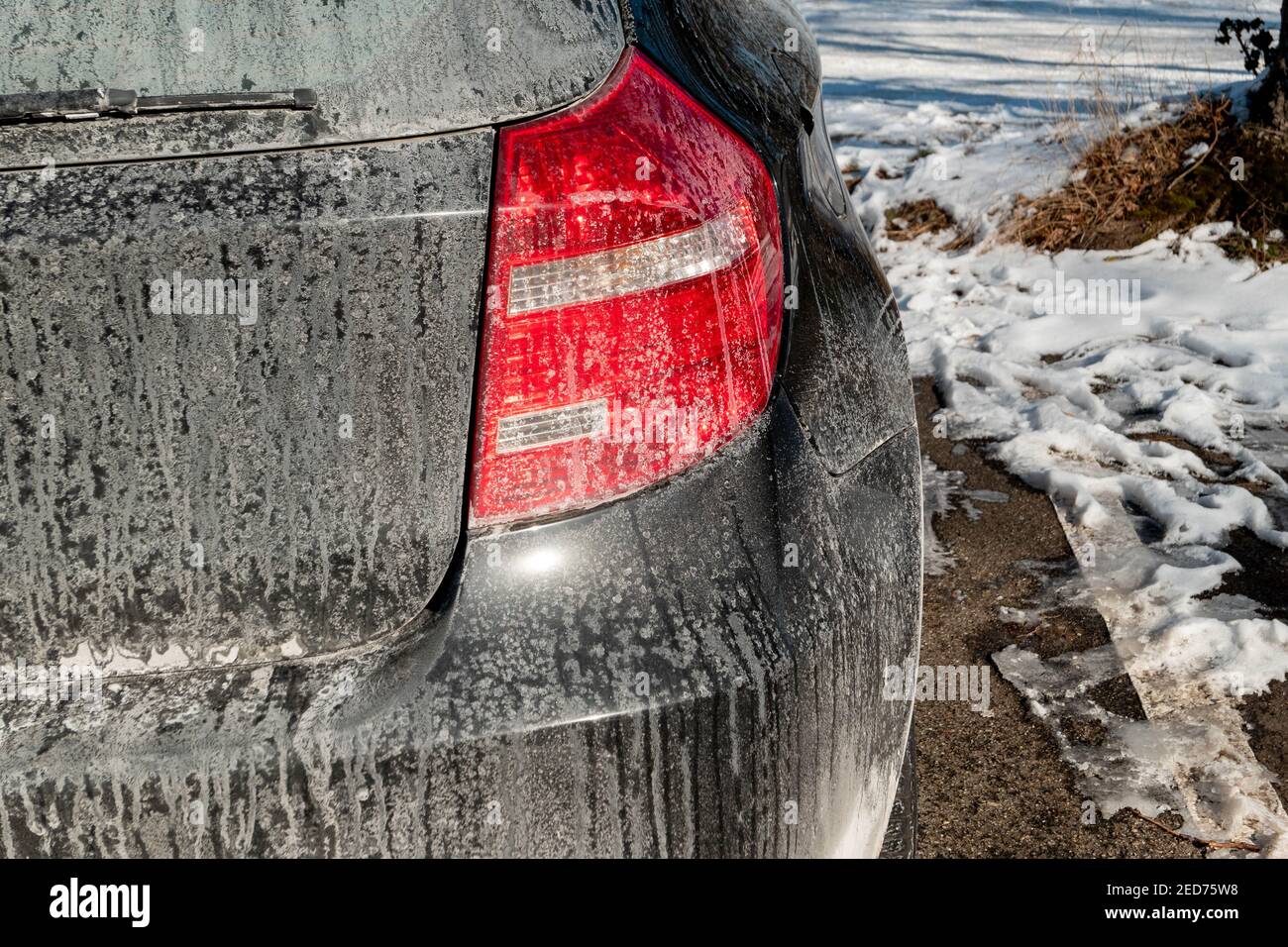 dirty black car in winter tail light extremely dirty Stock Photo - Alamy