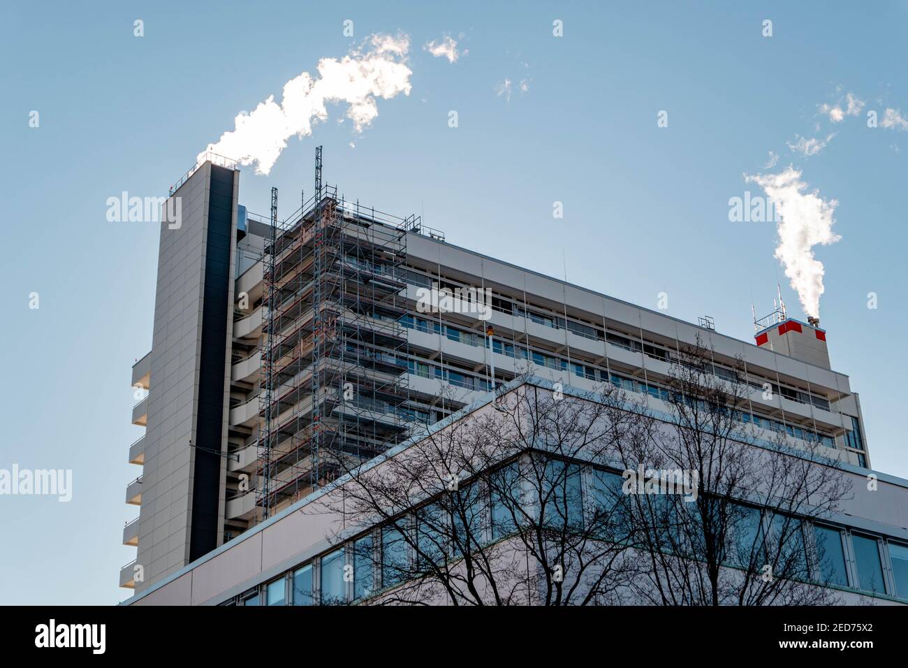 Hospital with blue sky and smoke Stock Photo - Alamy
