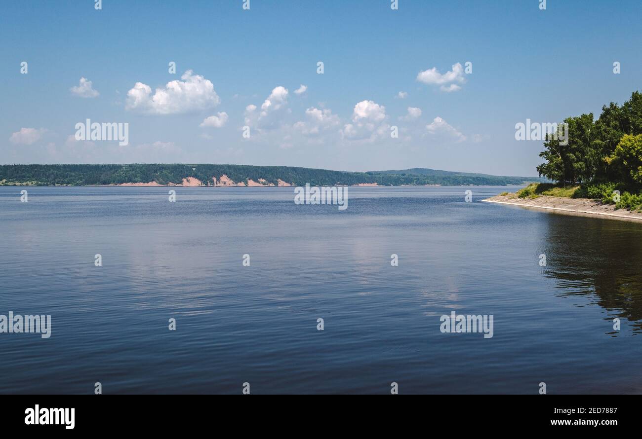 Lake landscape with clouds, wooded shoreline Stock Photo - Alamy