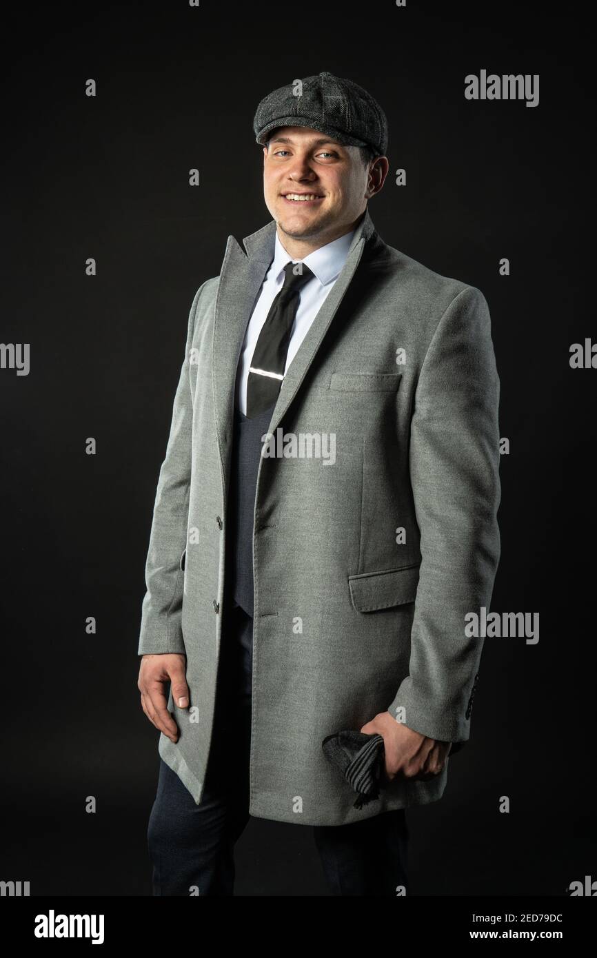 in a coat and a cap Young male three piece suit model, modern casual ...