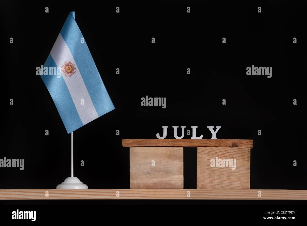Wooden calendar of Jule with Argentine flag on black background ...
