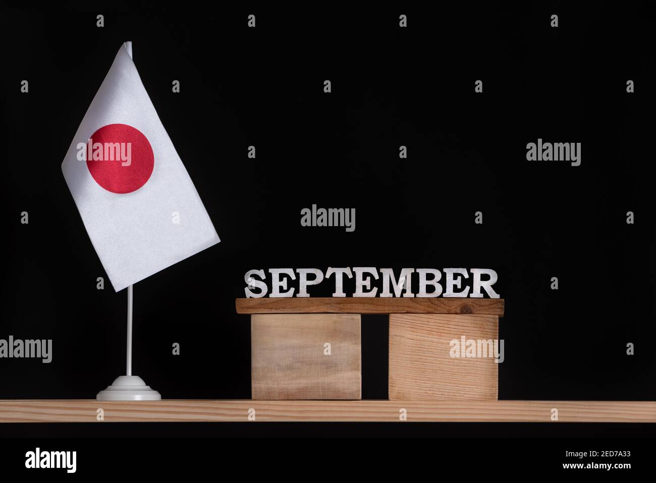 Wooden calendar of September with Japan flag on black background. Dates ...