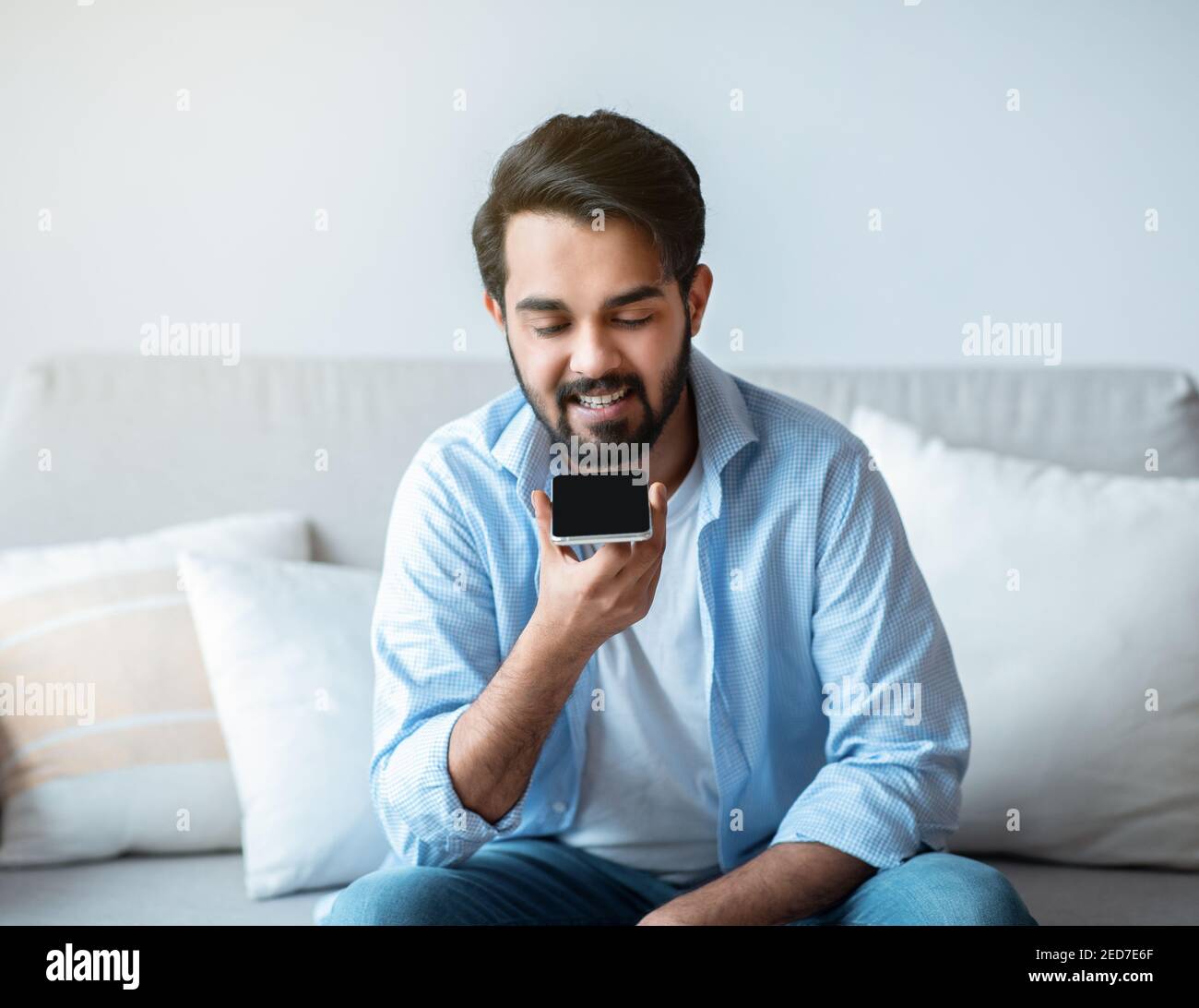 Smiling Arab Man Recording Voice Message On Smartphone Or Using Virtual ...