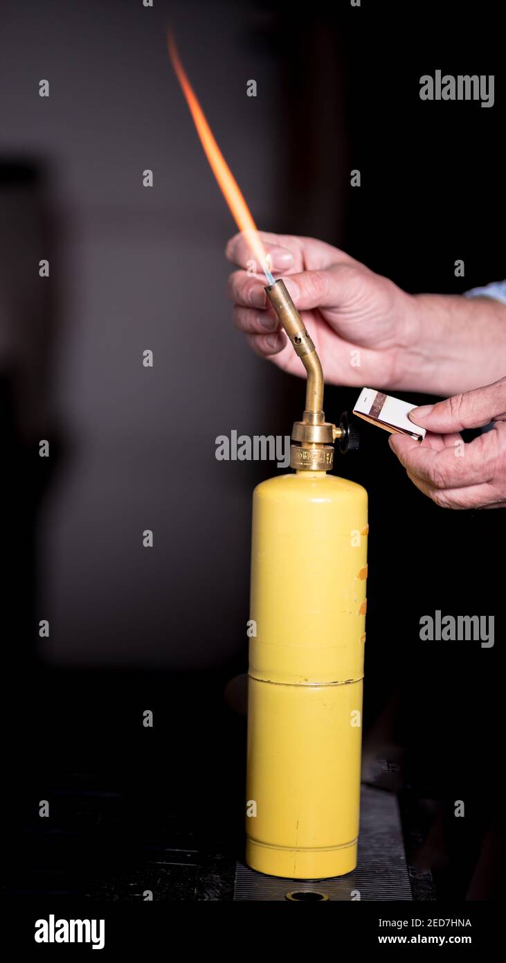 Flame ignites lighting a propane bottle Stock Photo - Alamy