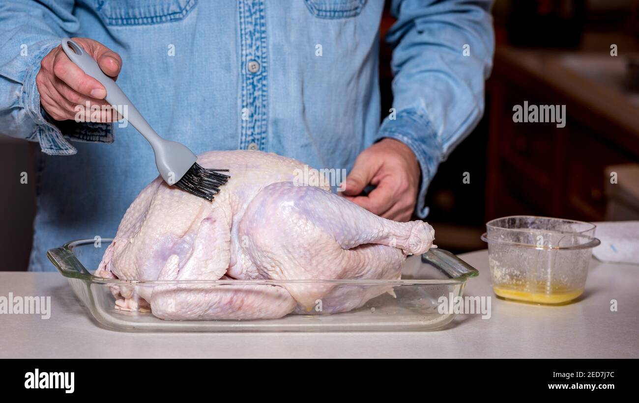 Turkey preparation to roast with brushing butter on the skin Stock ...