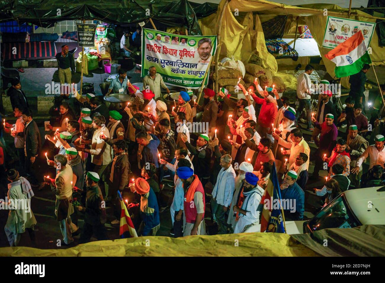Indian Farmers hold lit candles during a candlelight march in ...